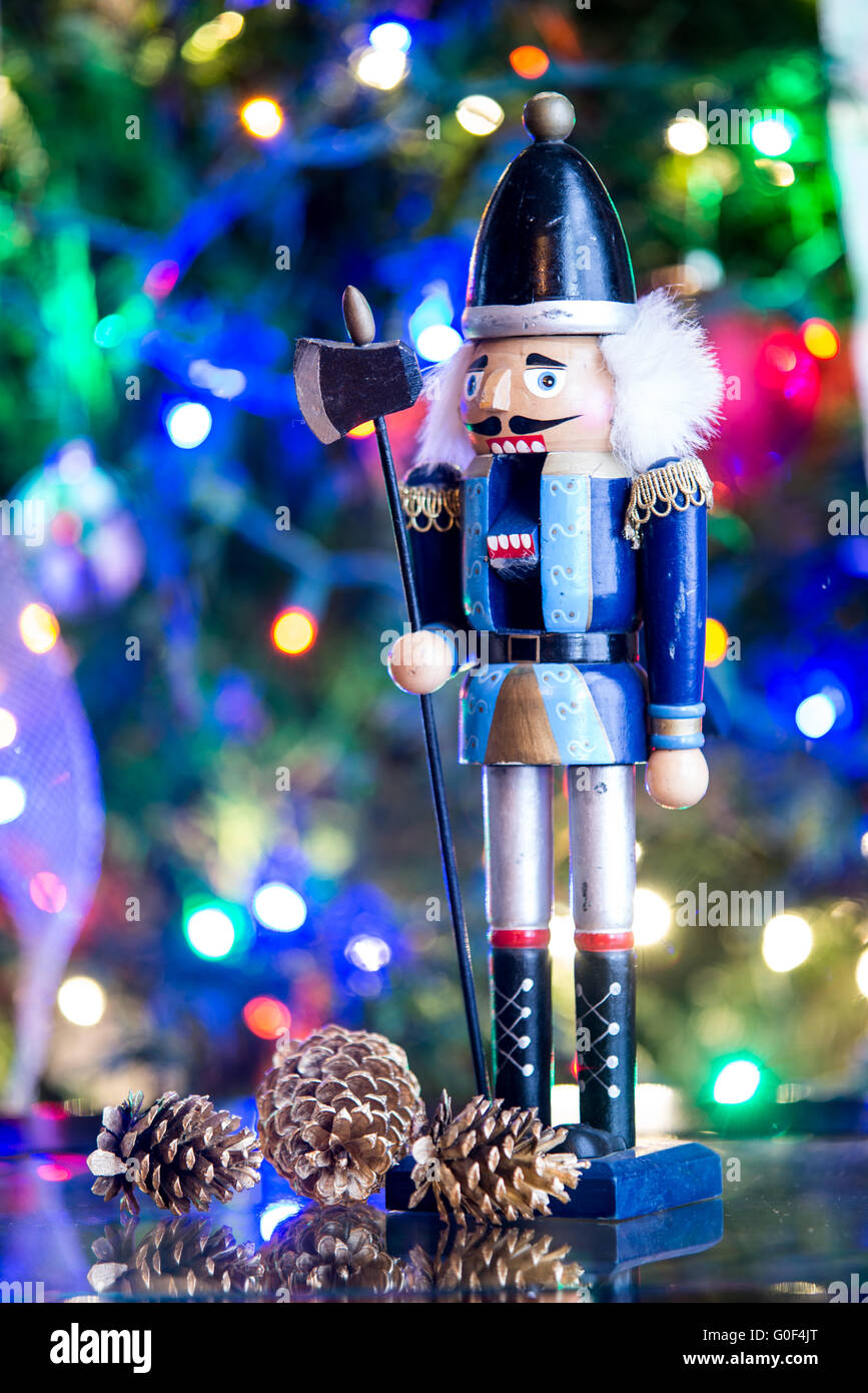 Soldier nutcracker statue standing in front of decorated Christmas tree ...