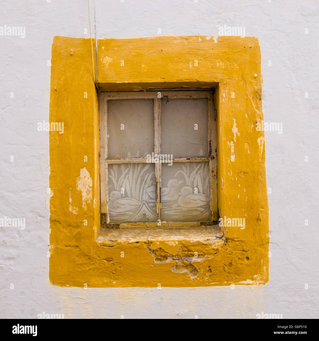 a small square window wth a yellow frame Stock Photo - Alamy