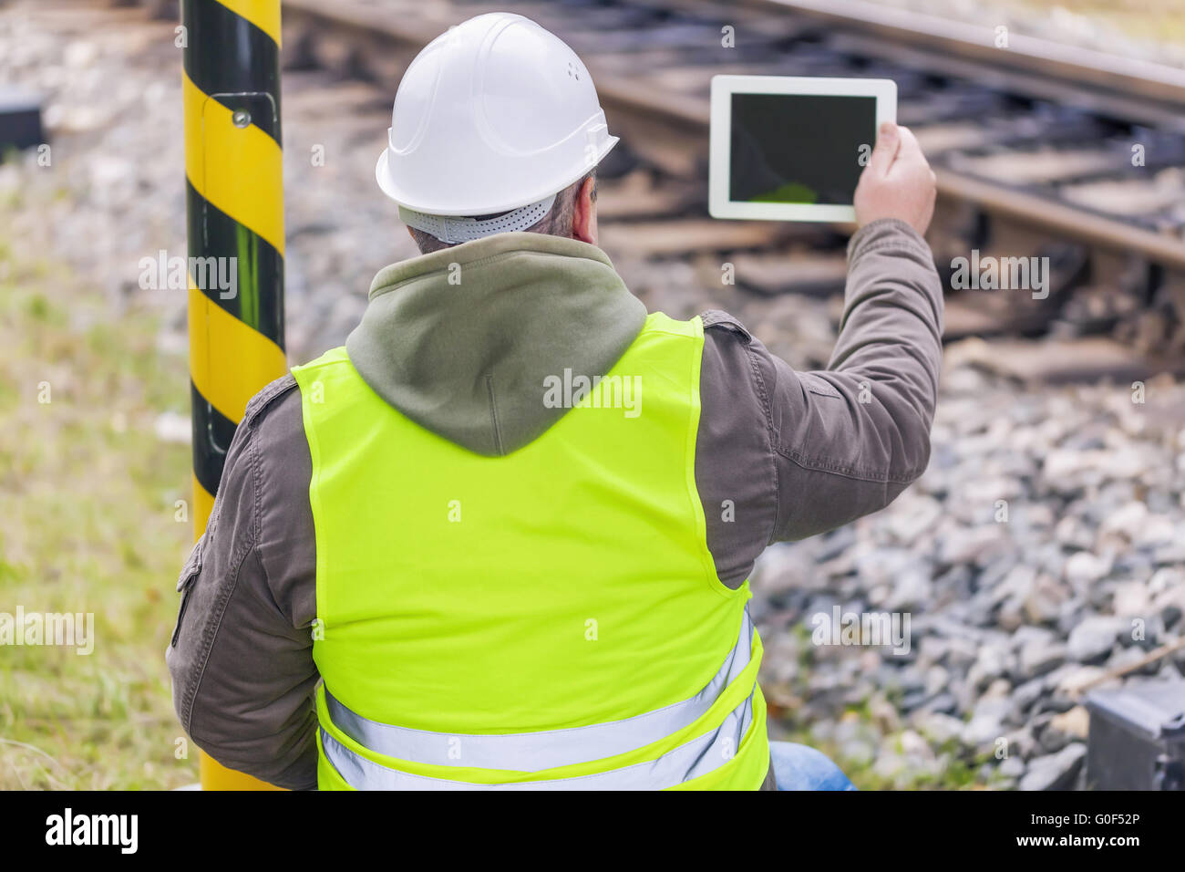 Engineer filmed the railway with tablet PC Stock Photo - Alamy