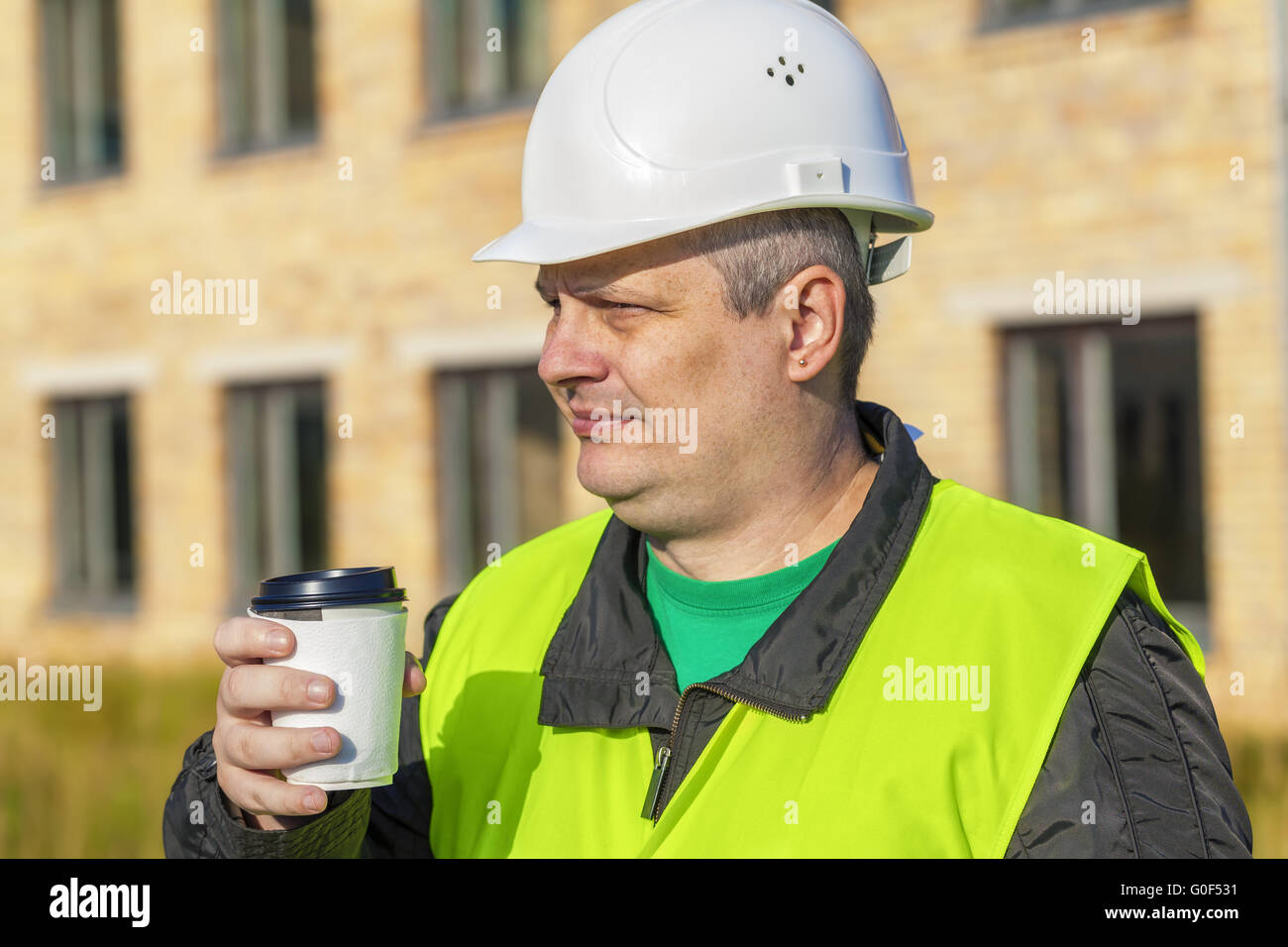 Construction Engineer with cup of coffee near building Stock Photo - Alamy
