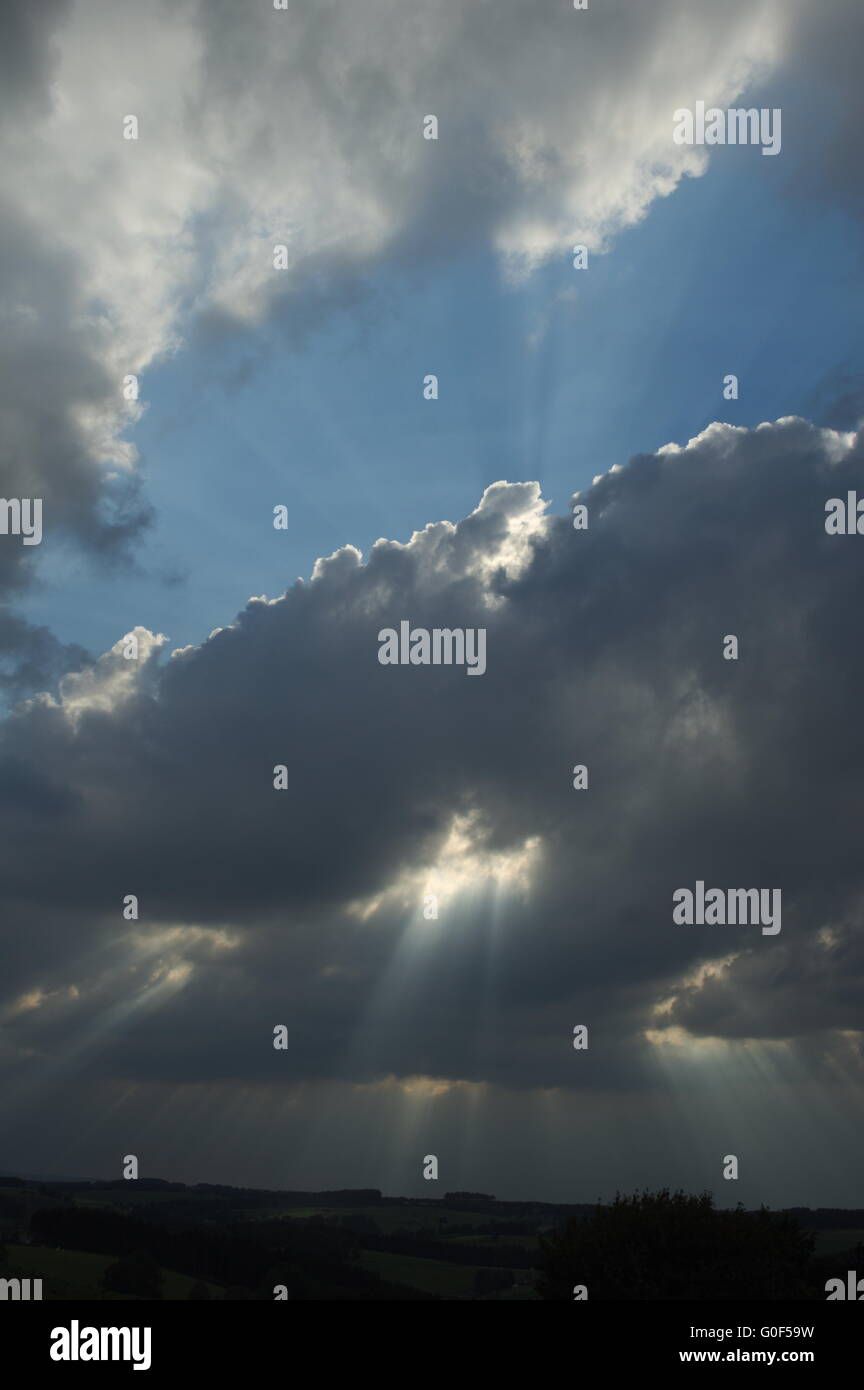 Sunbeams breaking through clouds Stock Photo - Alamy