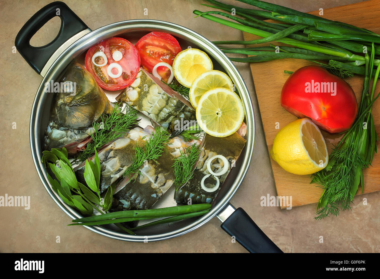 Fish and components for her preparation in a large Stock Photo - Alamy