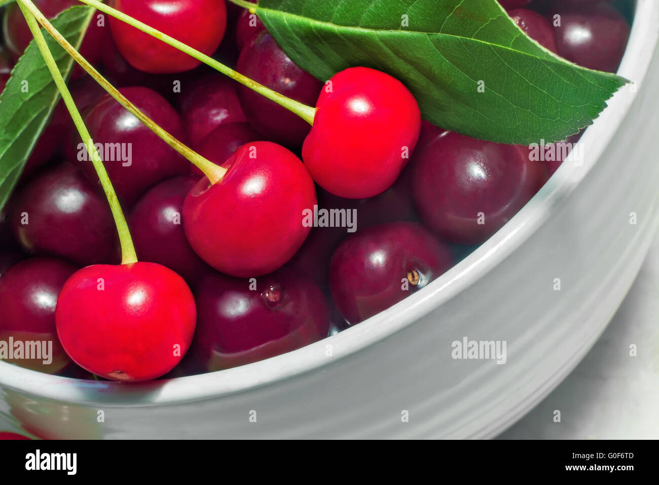 Big ripe cherry in a ceramic vase Stock Photo - Alamy