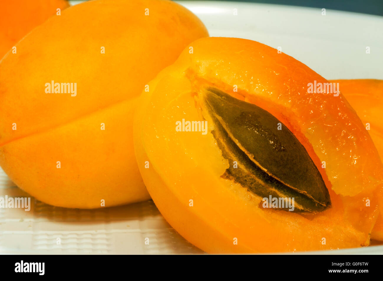 Cut a ripe apricot with bone and flesh Stock Photo - Alamy