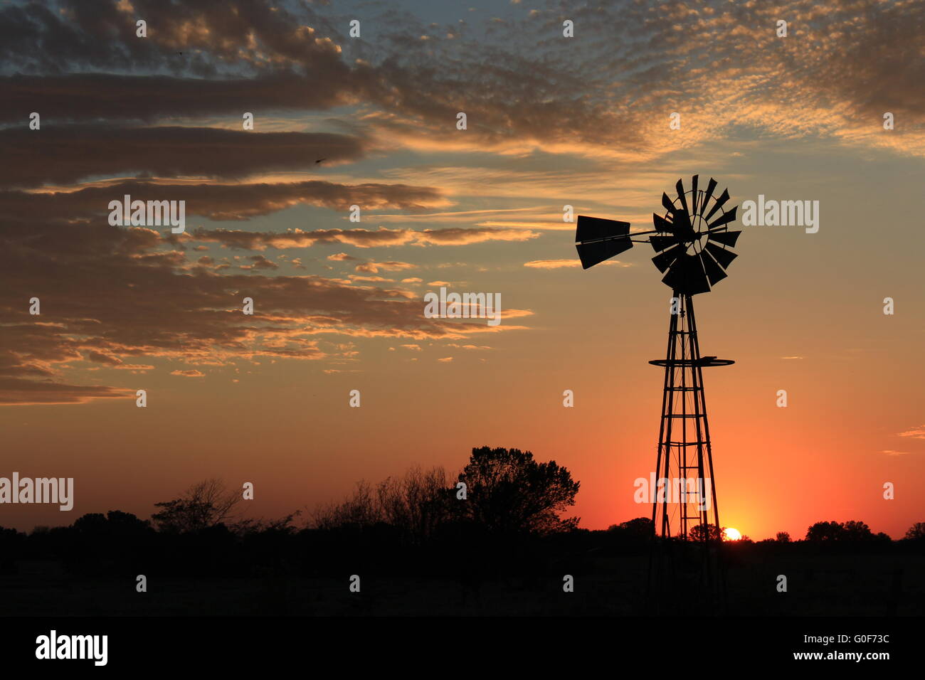 Kansas Golden Windmill Sunset Stock Photo - Alamy