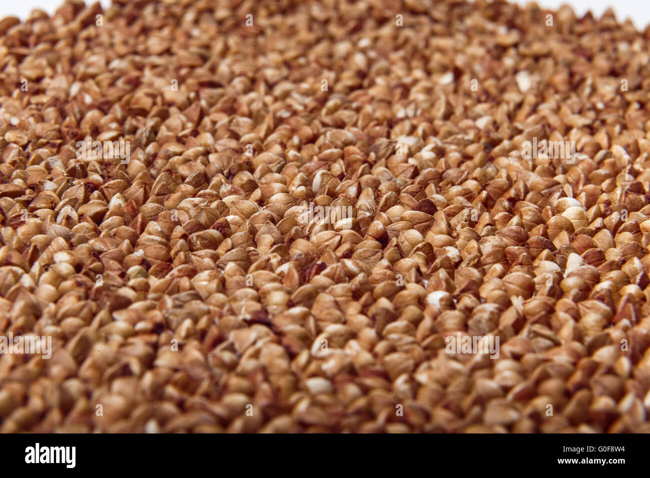 Uncooked buckwheat closeup macro isolated Stock Photo - Alamy