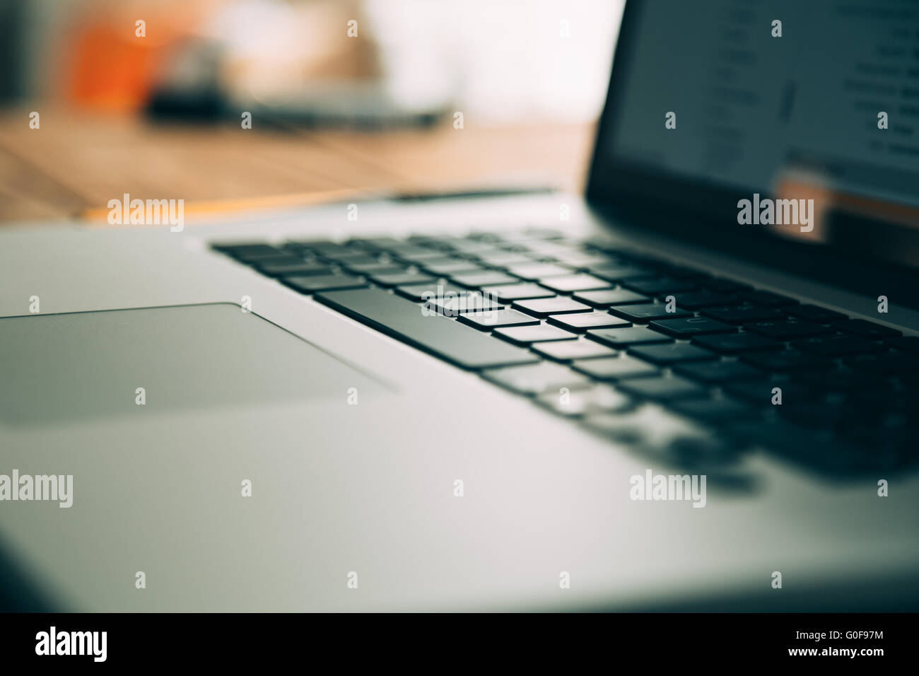 Workplace with open laptop on modern wooden desk Stock Photo - Alamy