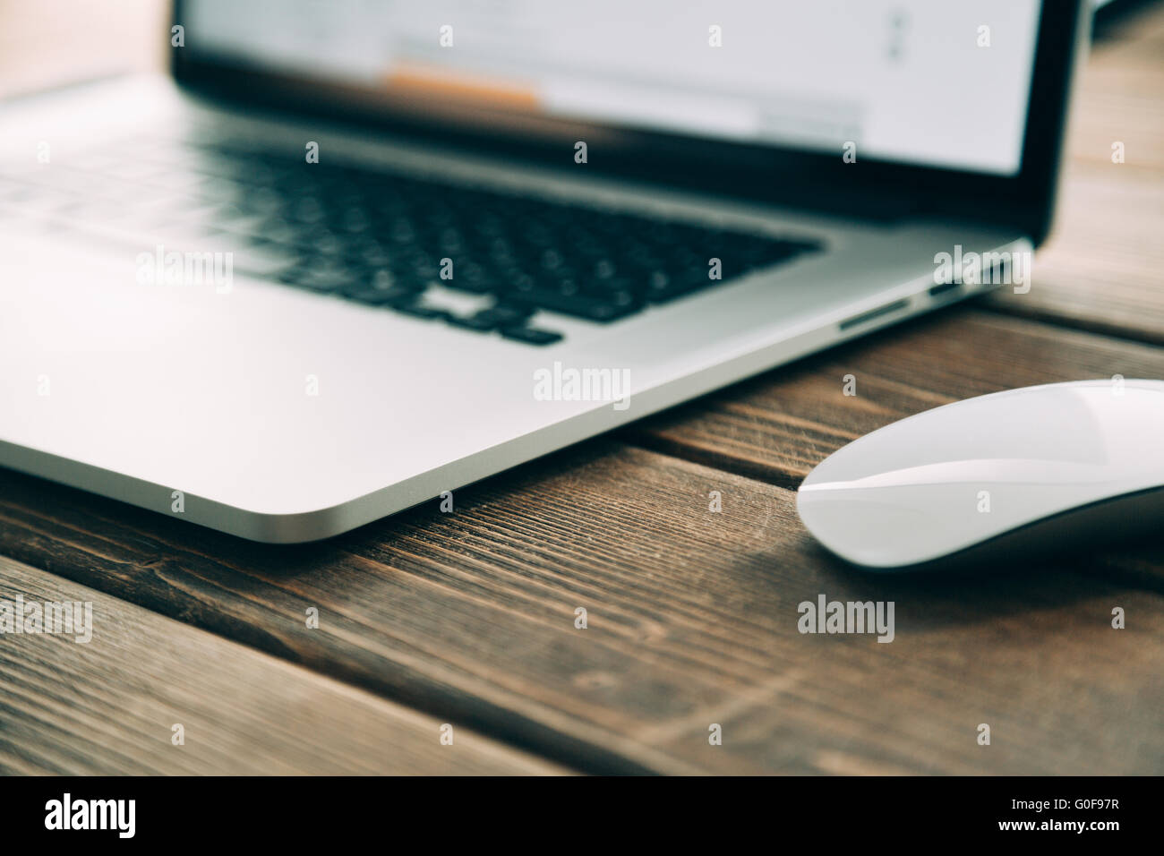 Workplace with open laptop on modern wooden desk Stock Photo - Alamy