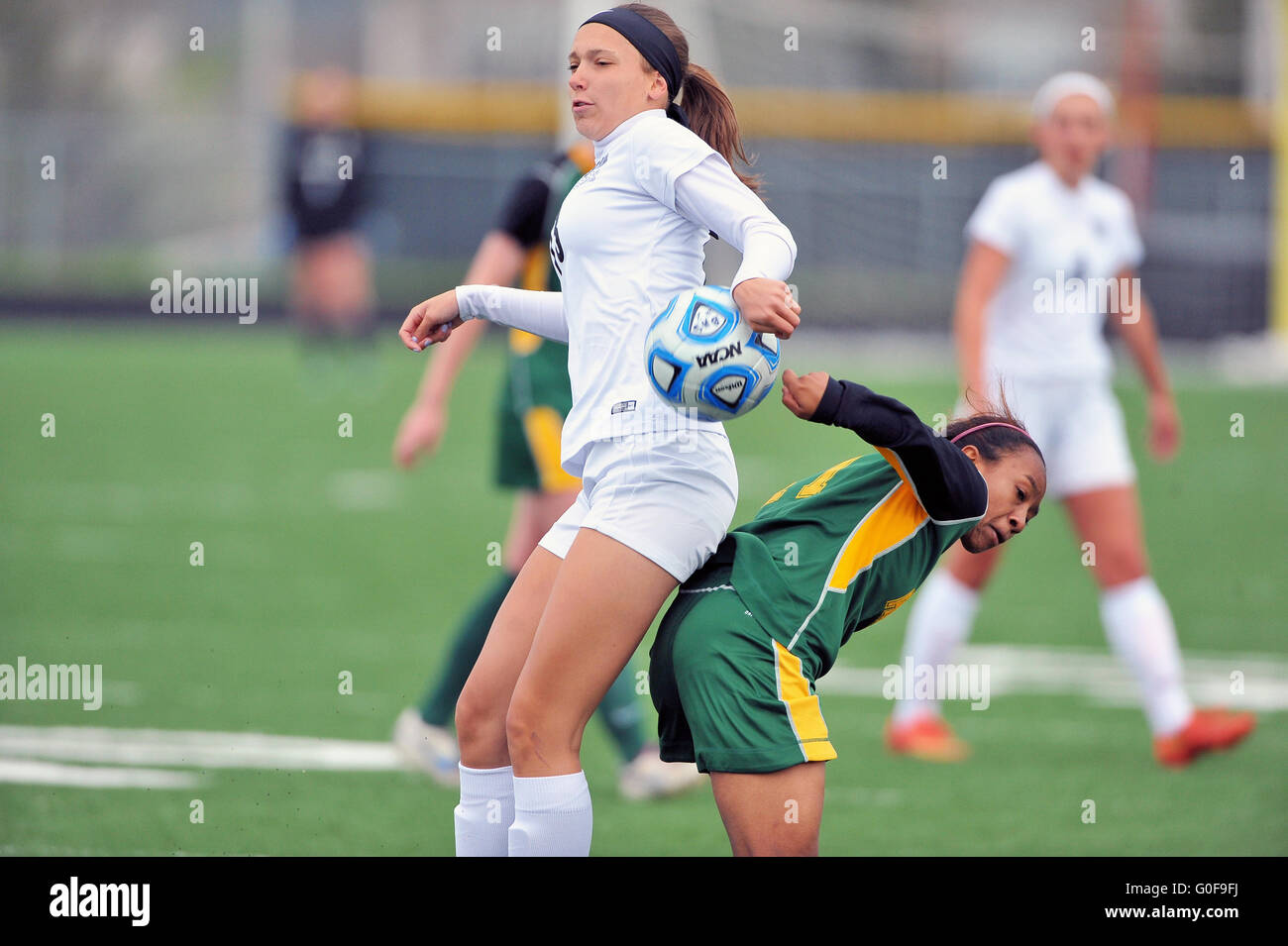 An attacking forward assumes a dominant posture over a defender during ...