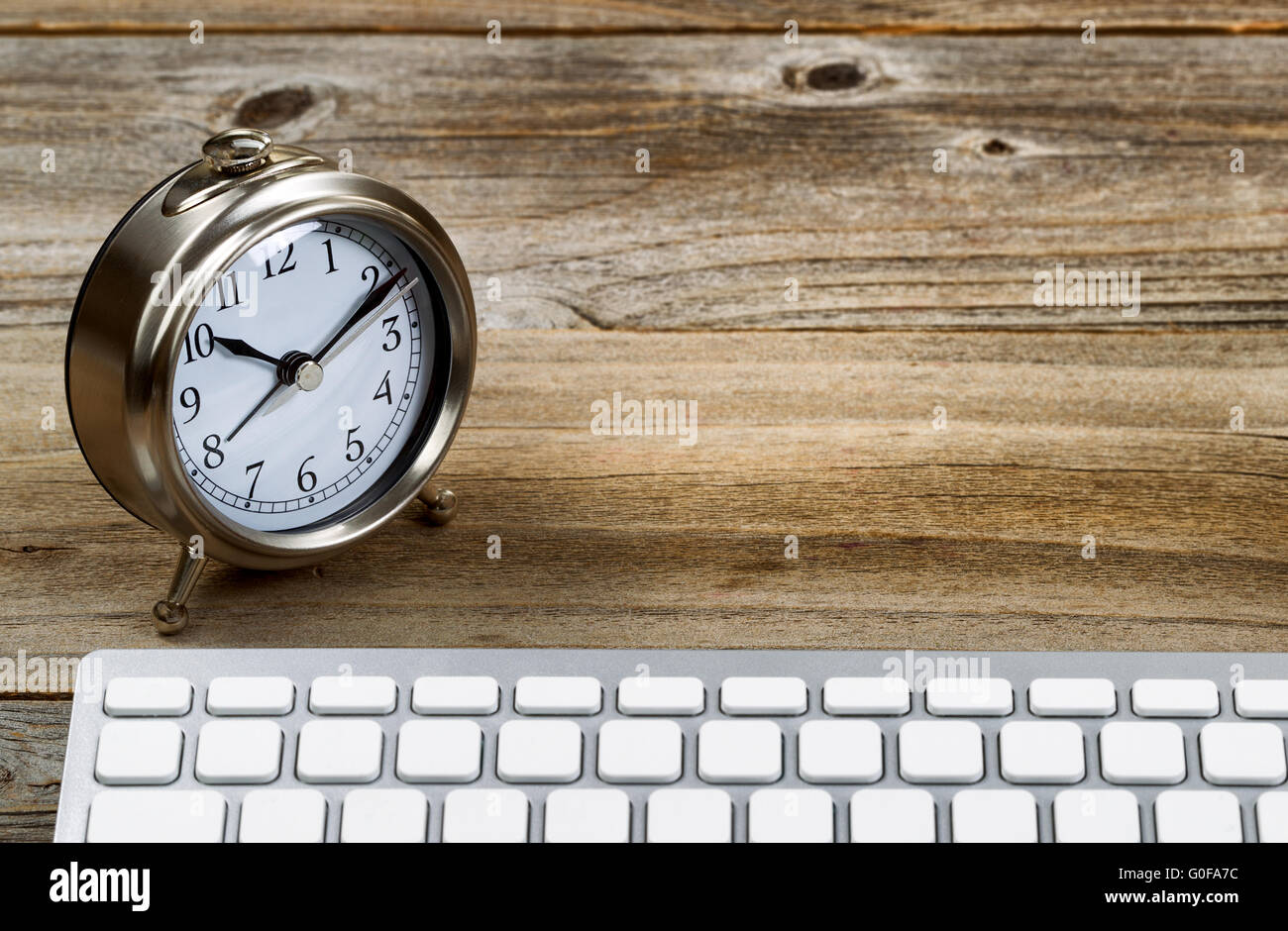 Rustic wooden desktop with retro clock and keyboard Stock Photo - Alamy