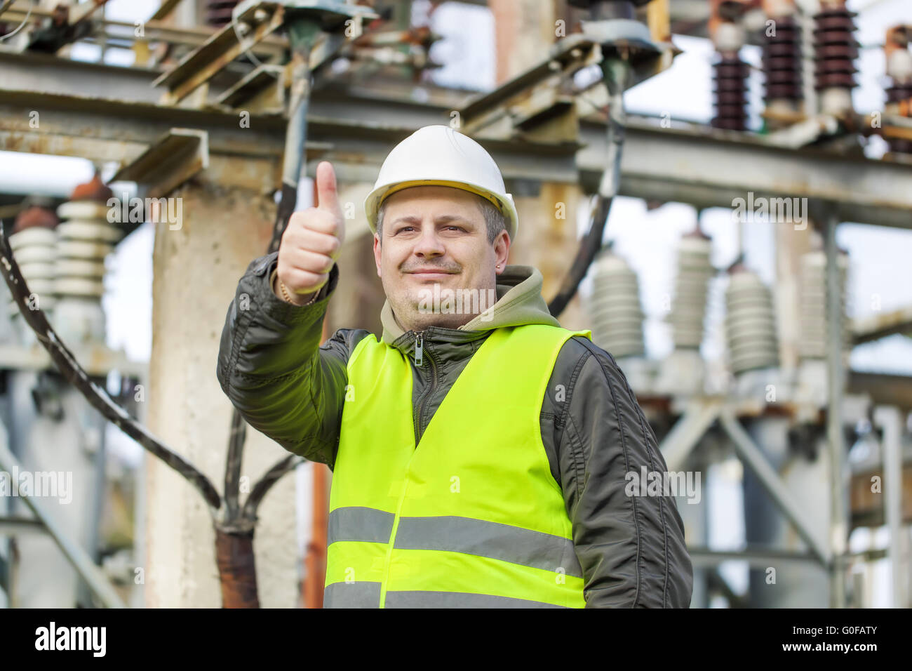 Electrician in electrical substation near to high Stock Photo - Alamy