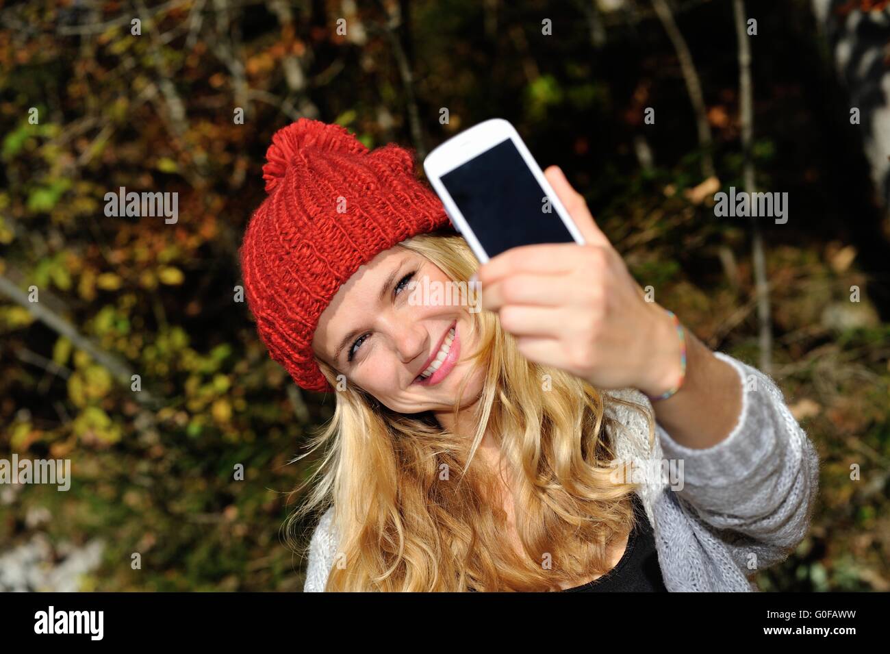 Young woman with red cap, taking a selfie Stock Photo - Alamy