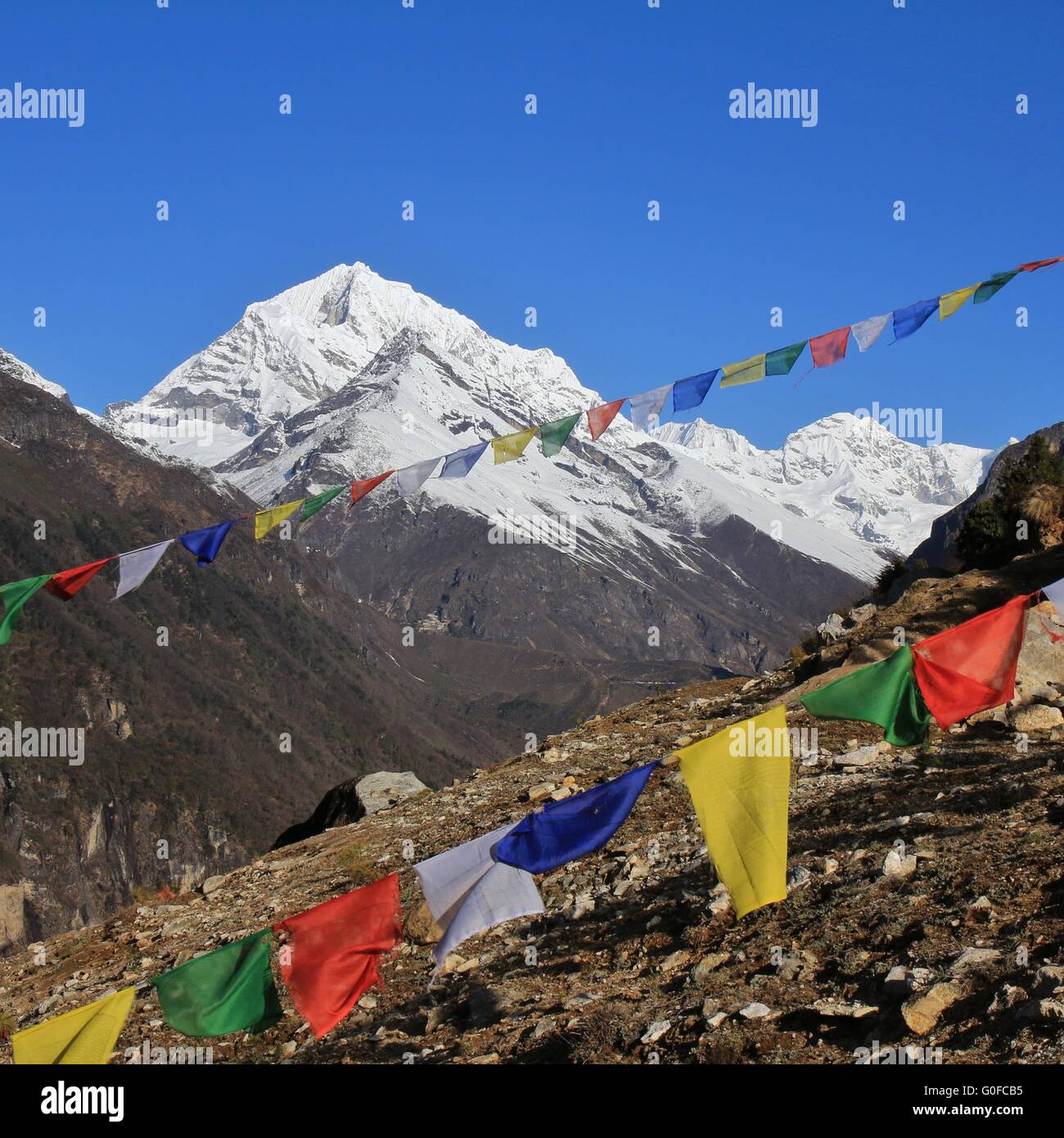 Prayer flags and snow capped mountain in the Himalayas Stock Photo - Alamy