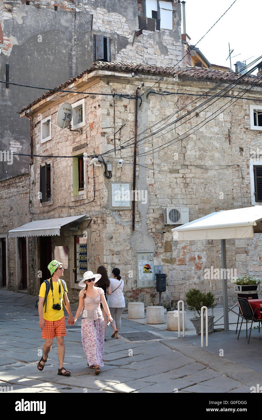 tourists visiting the narrow streets in the historic city of Pula in ...