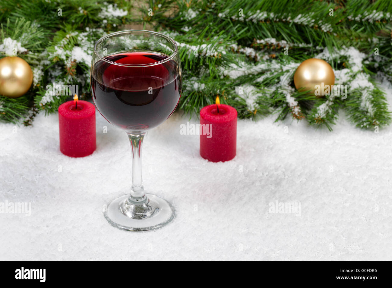 Red Wine with Christmas objects covered with fresh snow Stock Photo - Alamy