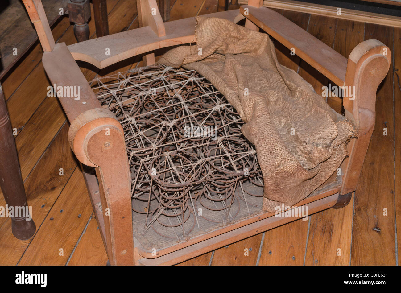 Broken old upholstered chair with springs Stock Photo - Alamy