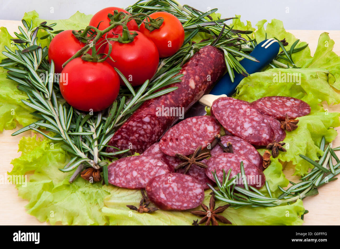 Slice sausage and fresh herbs Stock Photo - Alamy
