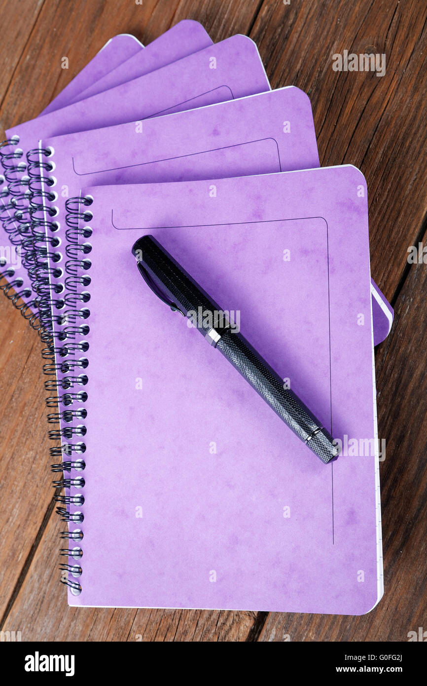 stack of notebooks and fountain pen on the table Stock Photo - Alamy