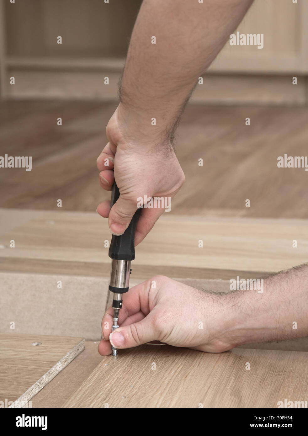 Hands with a screwdriver Stock Photo - Alamy