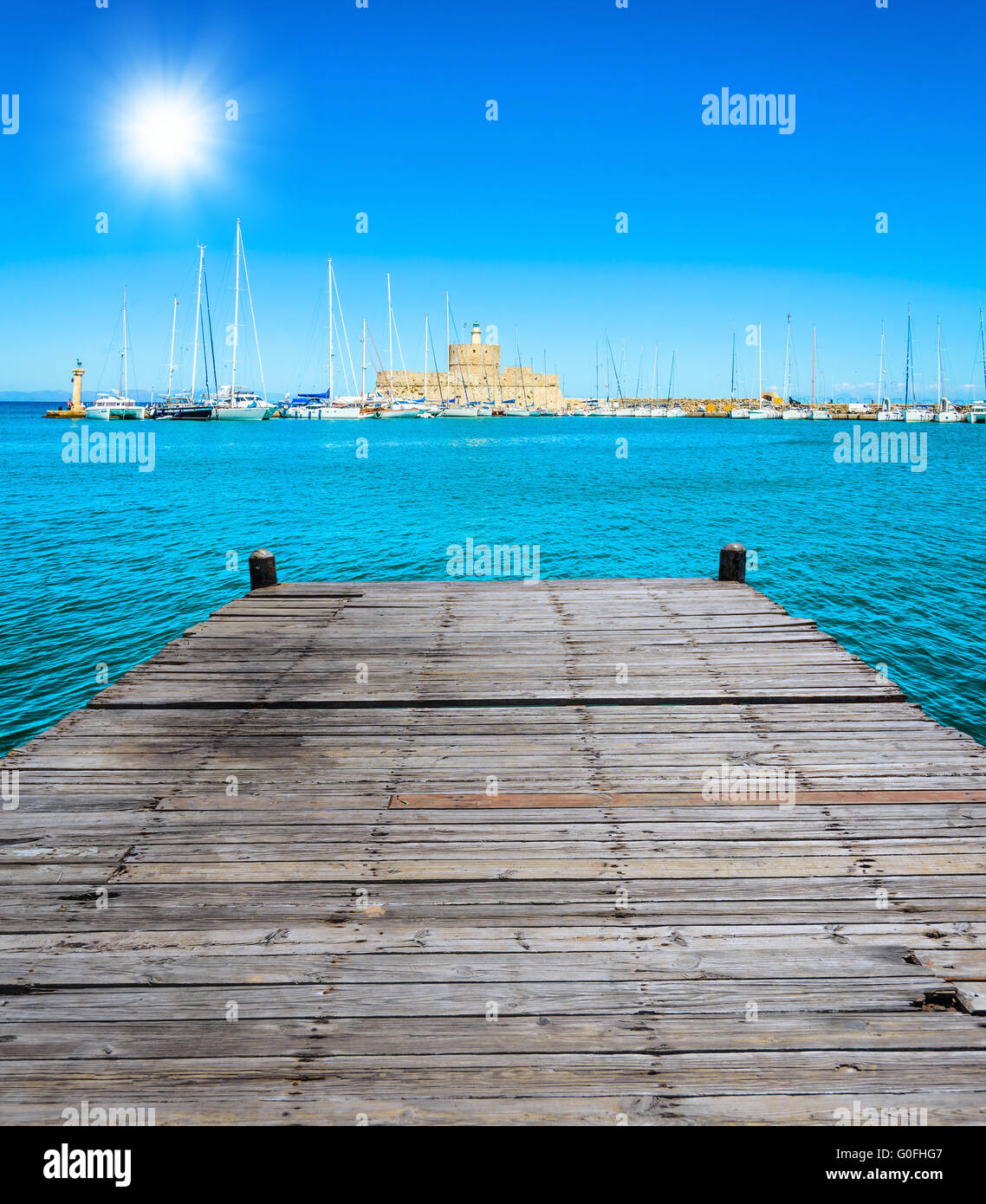 wooden batten bridge juts out into the expanse of the sea Stock Photo ...