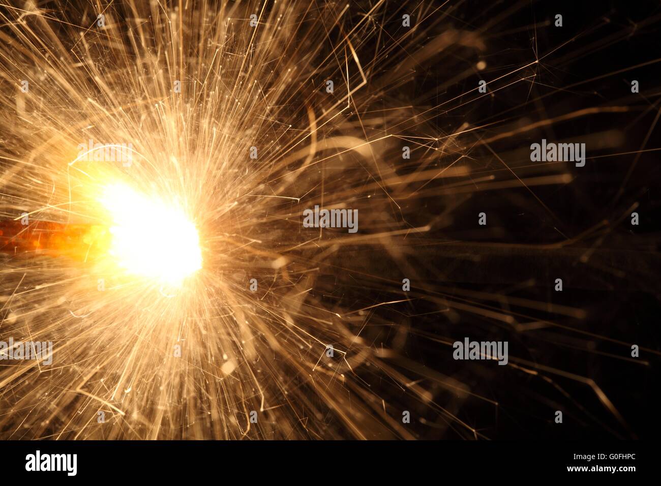 Macro photo of firework sparkler with black background Stock Photo - Alamy
