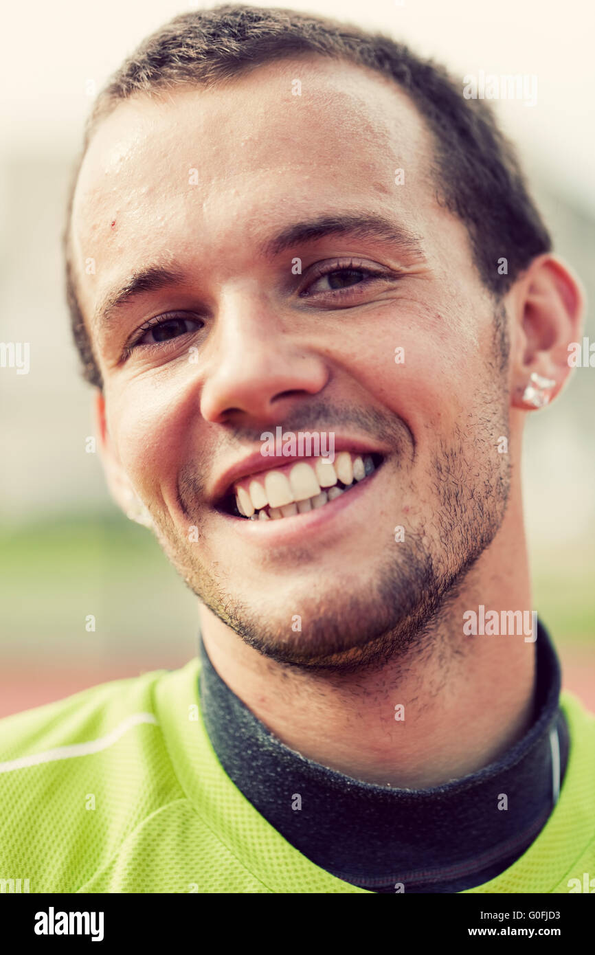 Portrait of a young active man smiling during sport training Stock ...