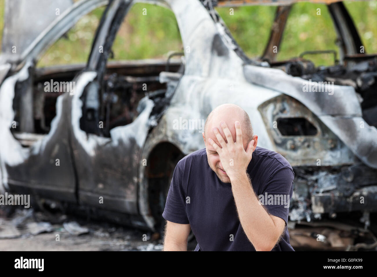 Crying upset man at arson fire burnt car vehicle Stock Photo - Alamy