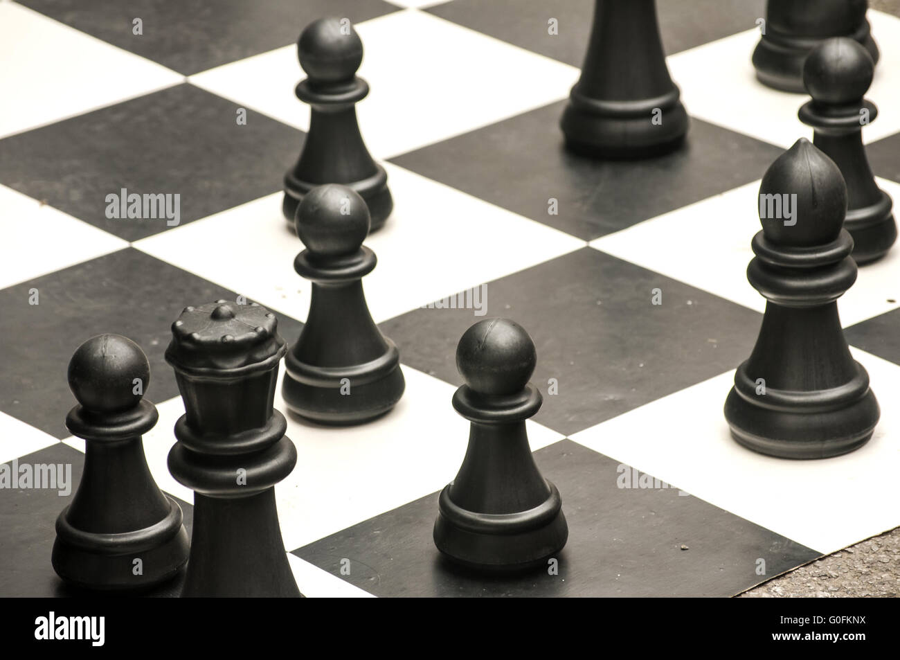 Part of checkerboard with large chess pieces Stock Photo - Alamy