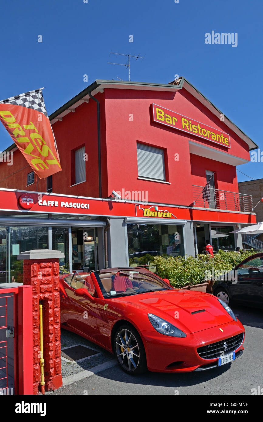 red sports car, red house Stock Photo - Alamy