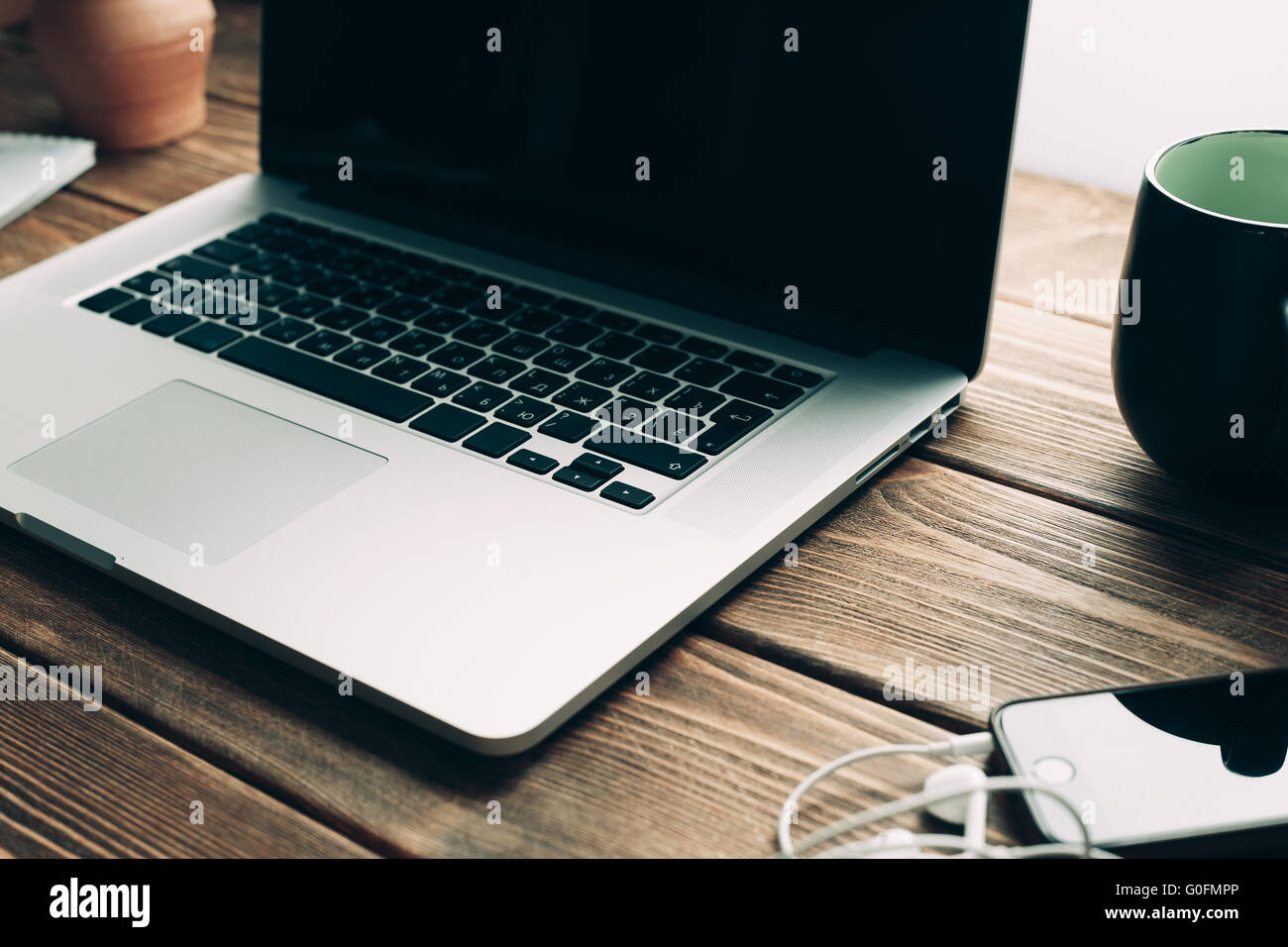 Workplace with open laptop on modern wooden desk Stock Photo - Alamy