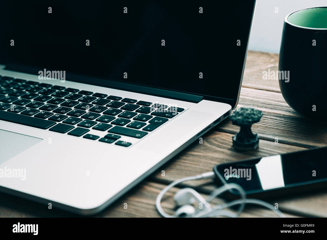 Workplace with open laptop on modern wooden desk Stock Photo - Alamy