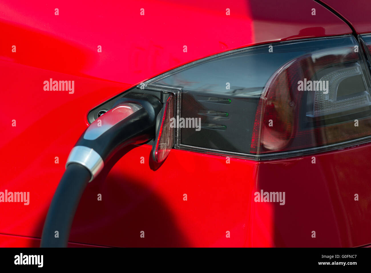 Charging red electric car Stock Photo - Alamy