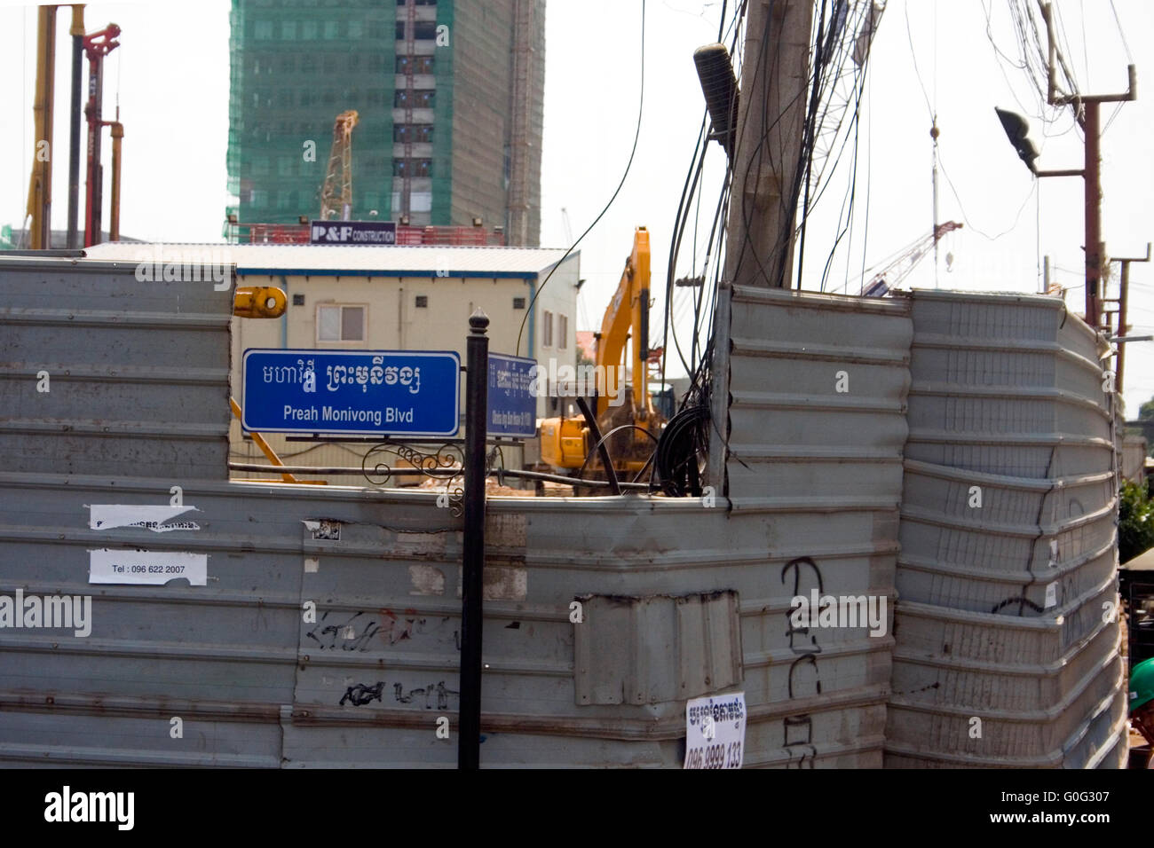 A construction site is walled off by a fence on a major boulevard in ...