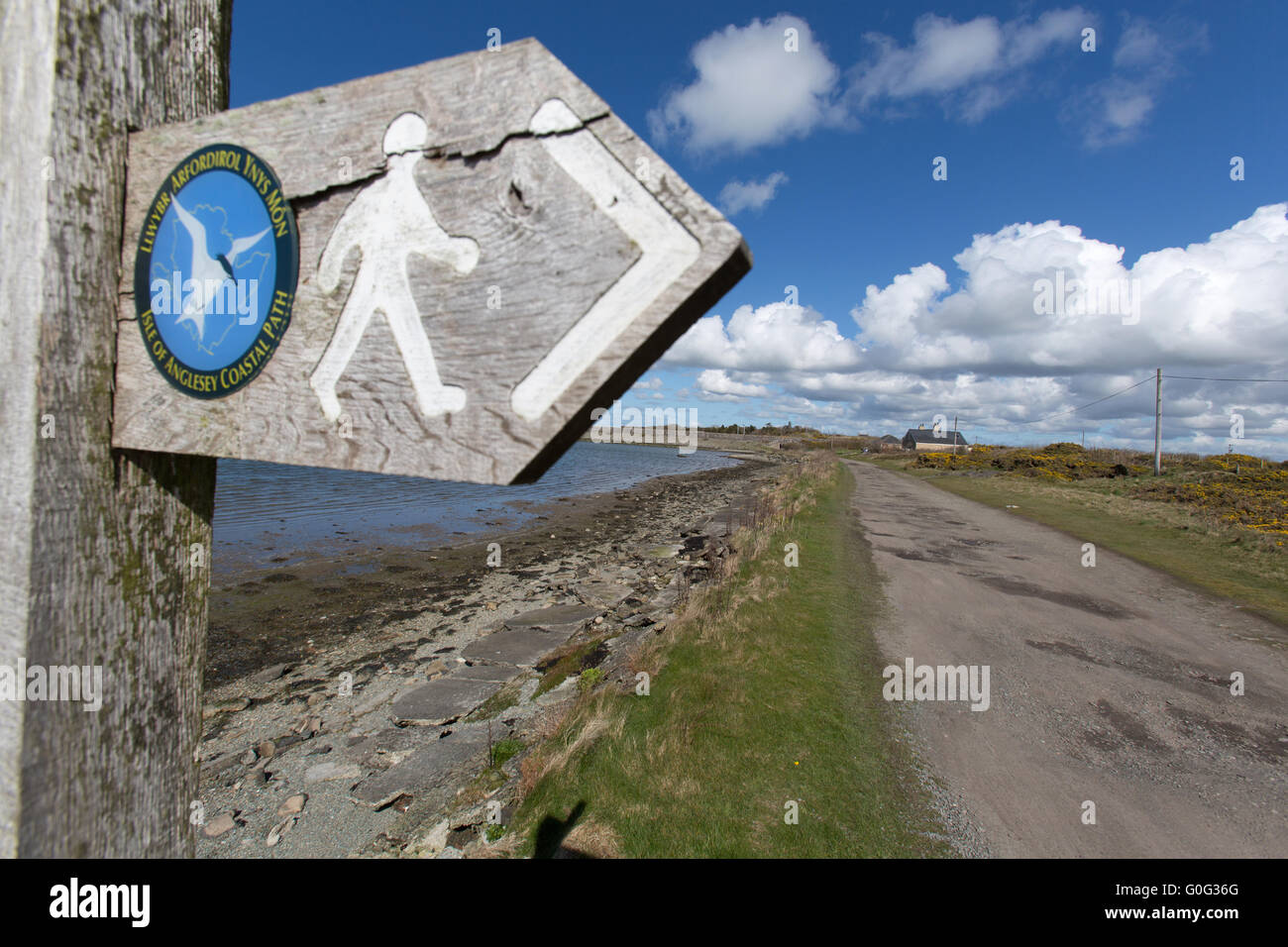 Picturesque view of an Anglesey Coastal Path direction sign, with the ...