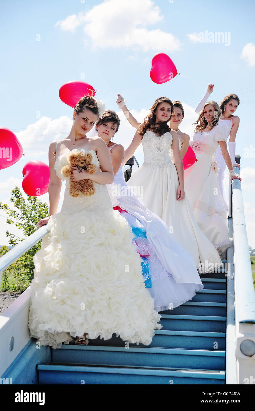 funny brides with balloons at the hand on the airport Stock Photo - Alamy