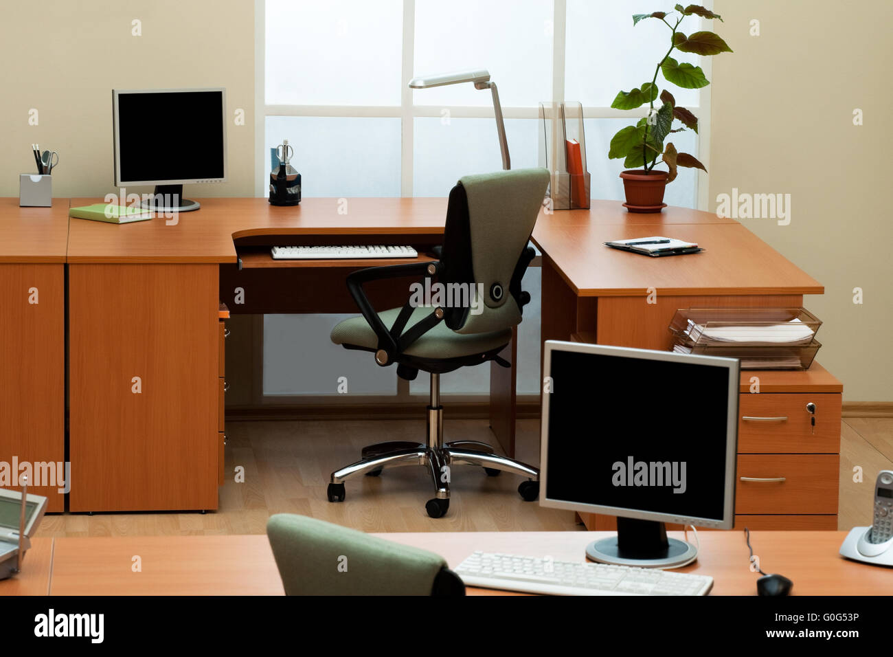computers on the desks in a modern office Stock Photo - Alamy