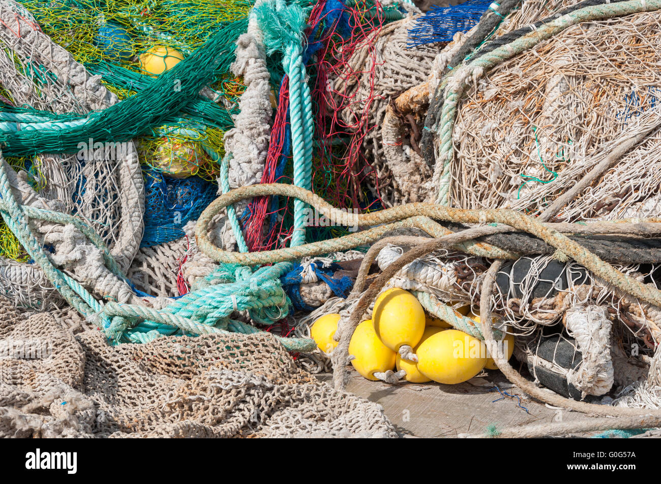 Fishing nets piled on the dock Stock Photo - Alamy