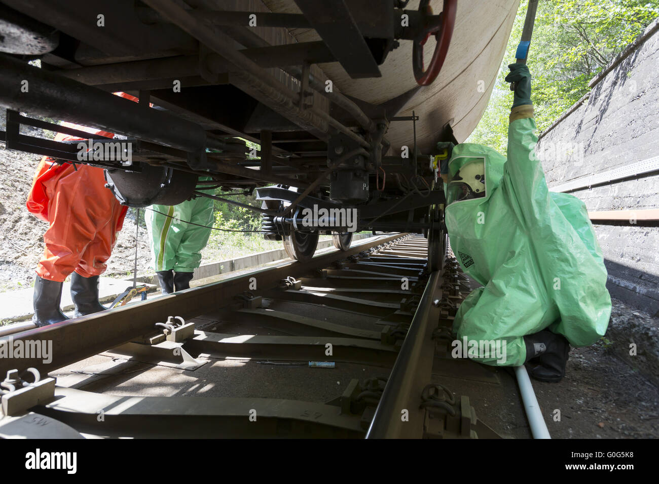 Toxic chemicals acids emergency team under tank Stock Photo - Alamy