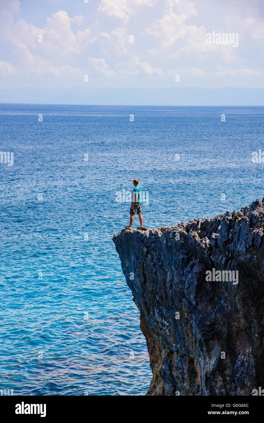 Male edge of a cliff Stock Photo - Alamy
