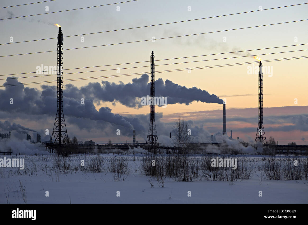 Refinery at sunset sky background. Frosty snowy winter evening Stock ...