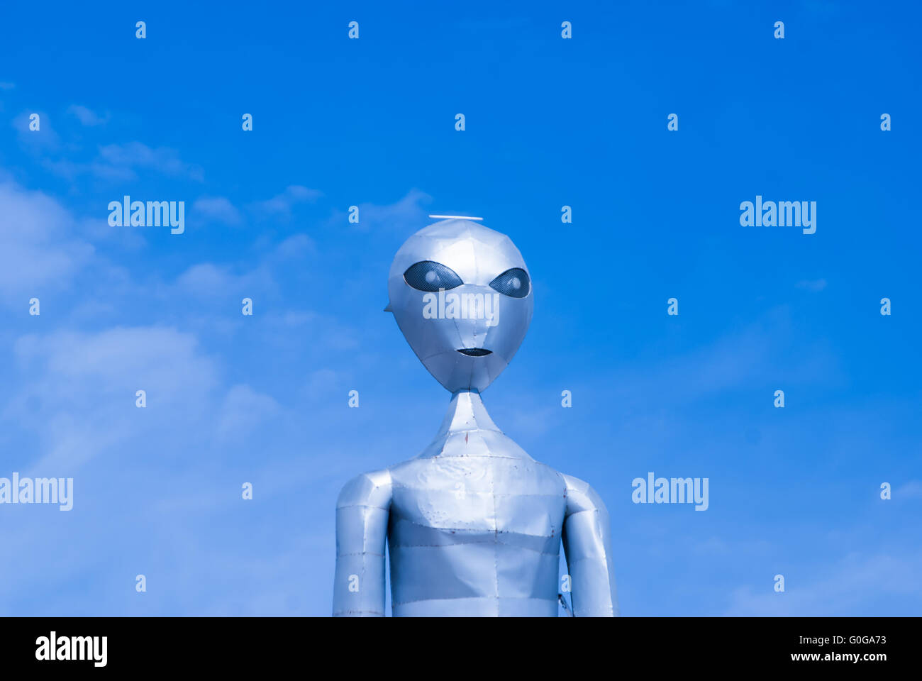 Alien on blue sky Stock Photo - Alamy