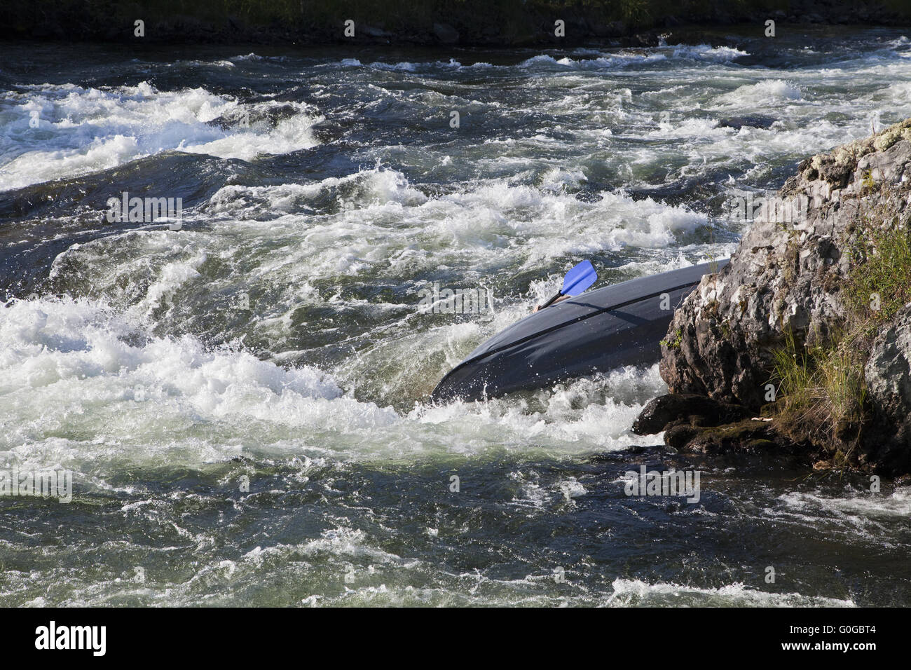 Kayaker turning over in whitewater Stock Photo - Alamy
