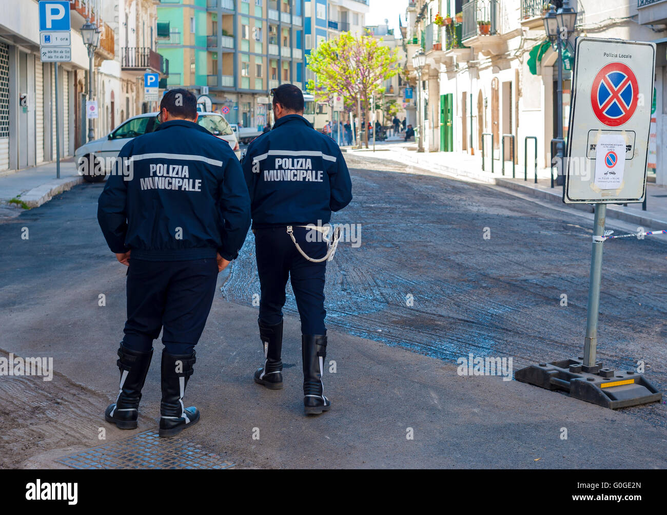two officers "Municipal Police" officers monitor the under progress of ...