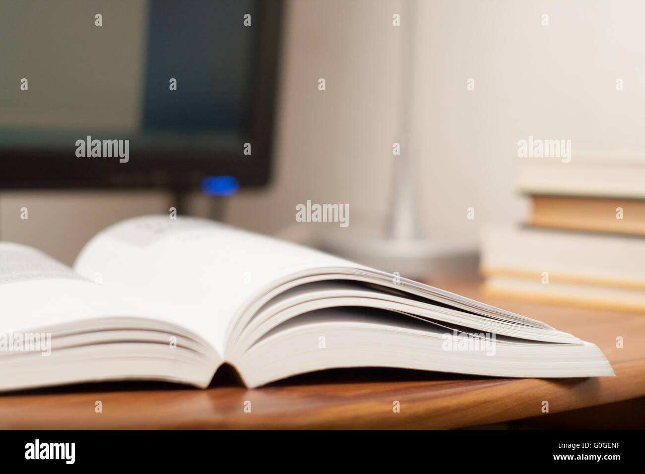 Open book on desk with computer Stock Photo - Alamy