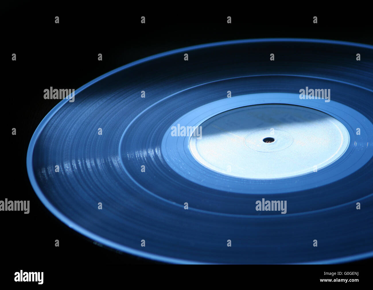 Blue vinyl record turntable on dark background Stock Photo - Alamy