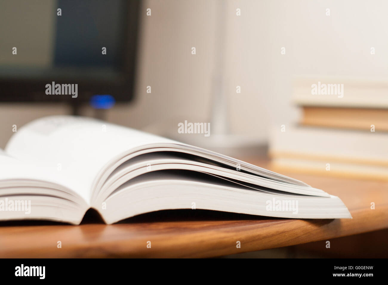 Open book on desk with computer Stock Photo - Alamy
