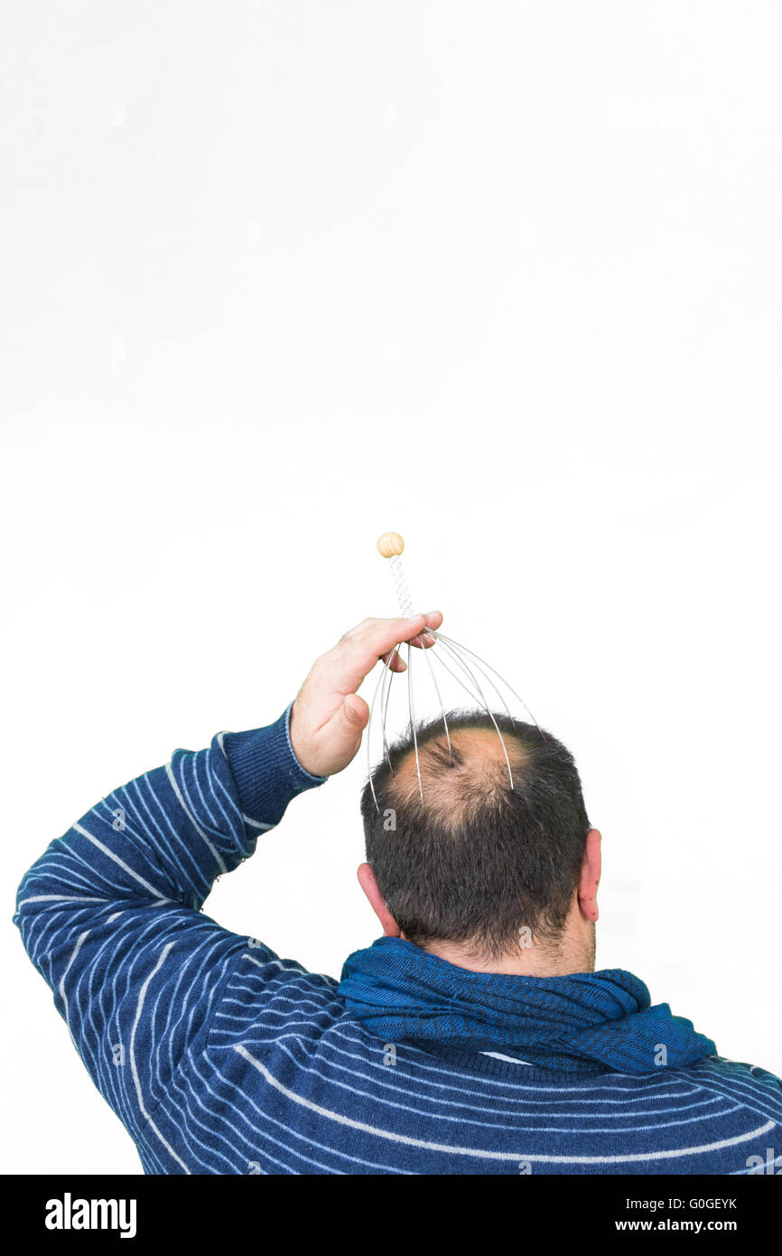 Man relaxes with the Genie head massager. Alternative Therapy. Indian ...