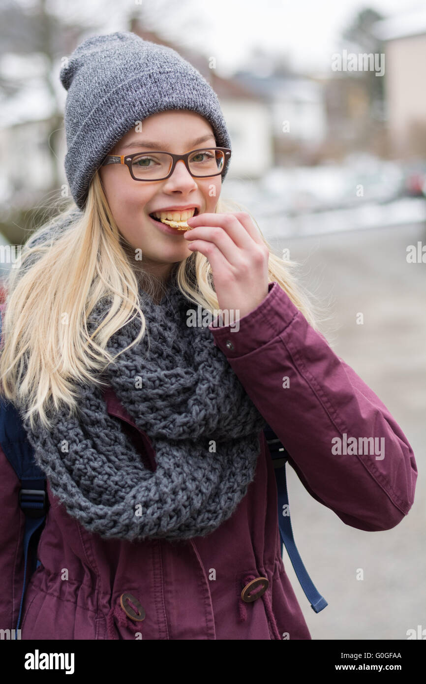 Laughing teenager eating biscuit - Portrait Stock Photo - Alamy