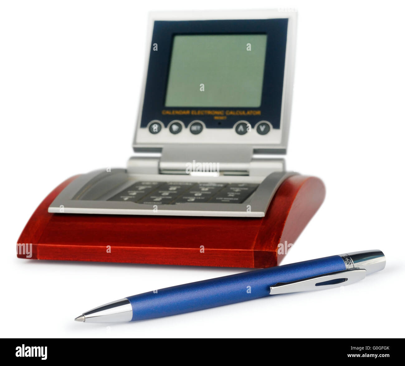 Electronic calendar with calculator and ball-point pen over white ...