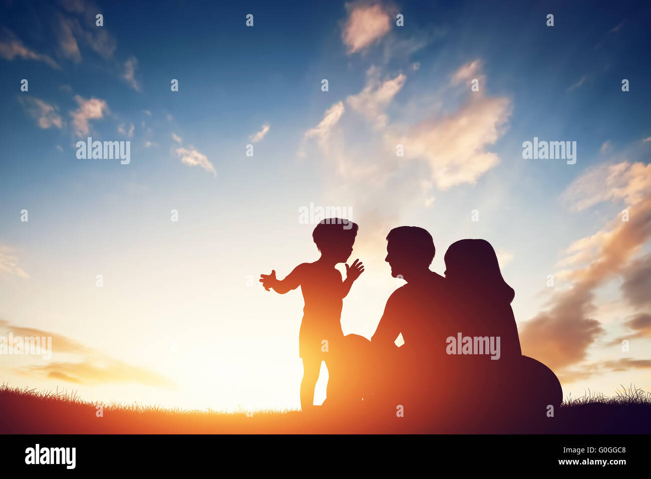 Happy family together, parents with their little child at sunset Stock ...